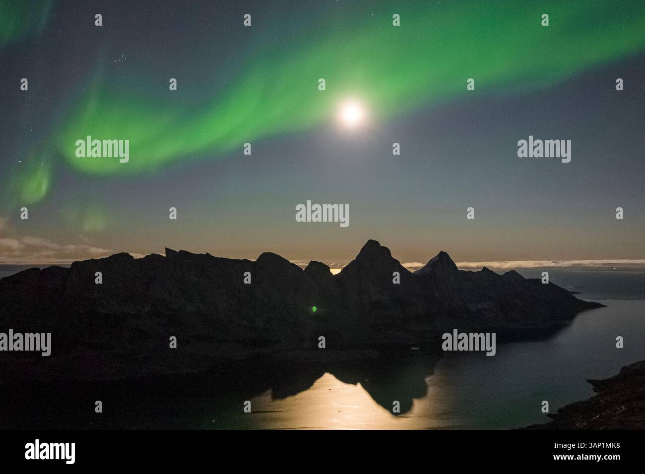 Aerial view of the northern lights over the fjords at night in ...