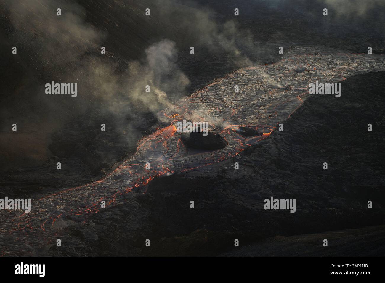 Aerial view of lava streaming down the mountain ridge, view of a river ...
