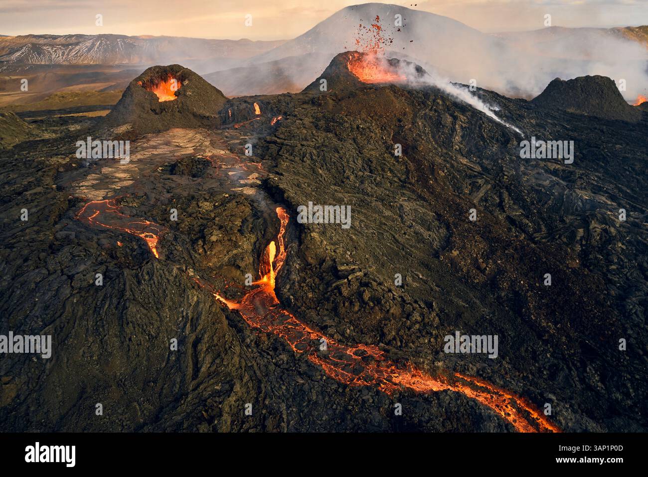 Aerial view of lava streaming down the mountain ridge, view of a river ...