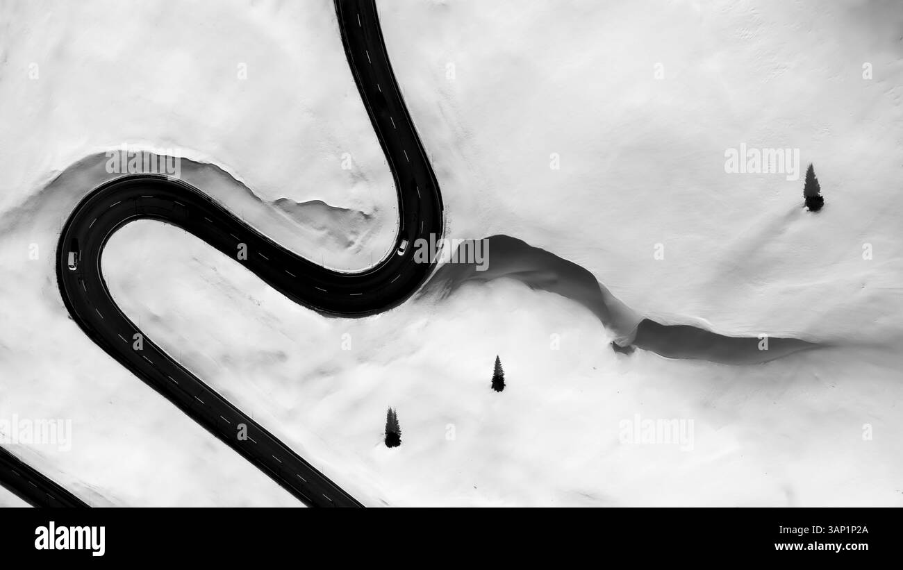 Aerial view of cars tackling the treacherous winding road through a ...