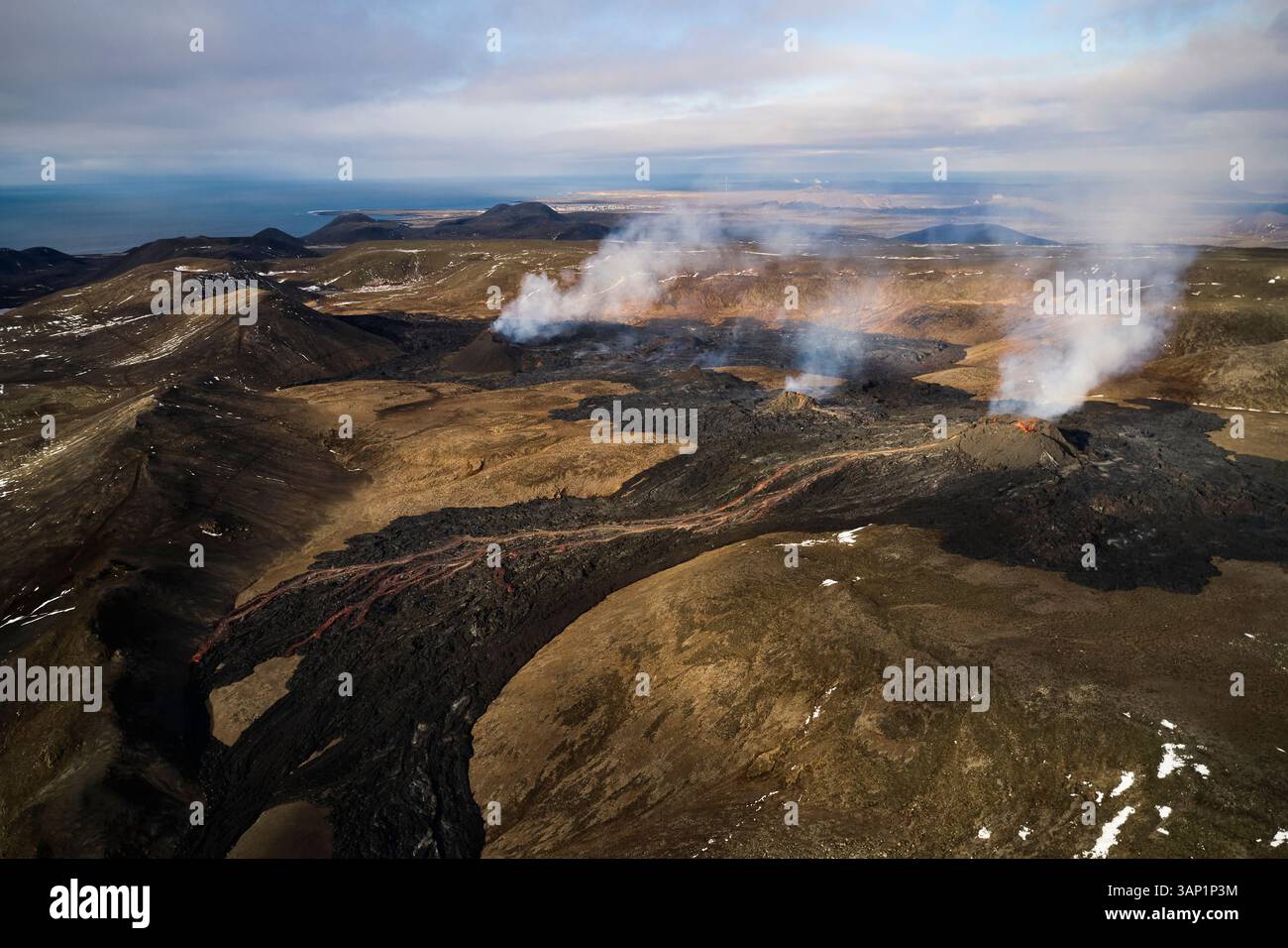 Aerial view of three volcano with activity smoking from the craters on ...