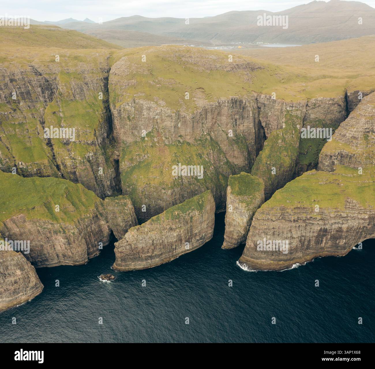 Aerial view of dramatic Dunnesdrangar rock formations and rugged cliffs ...