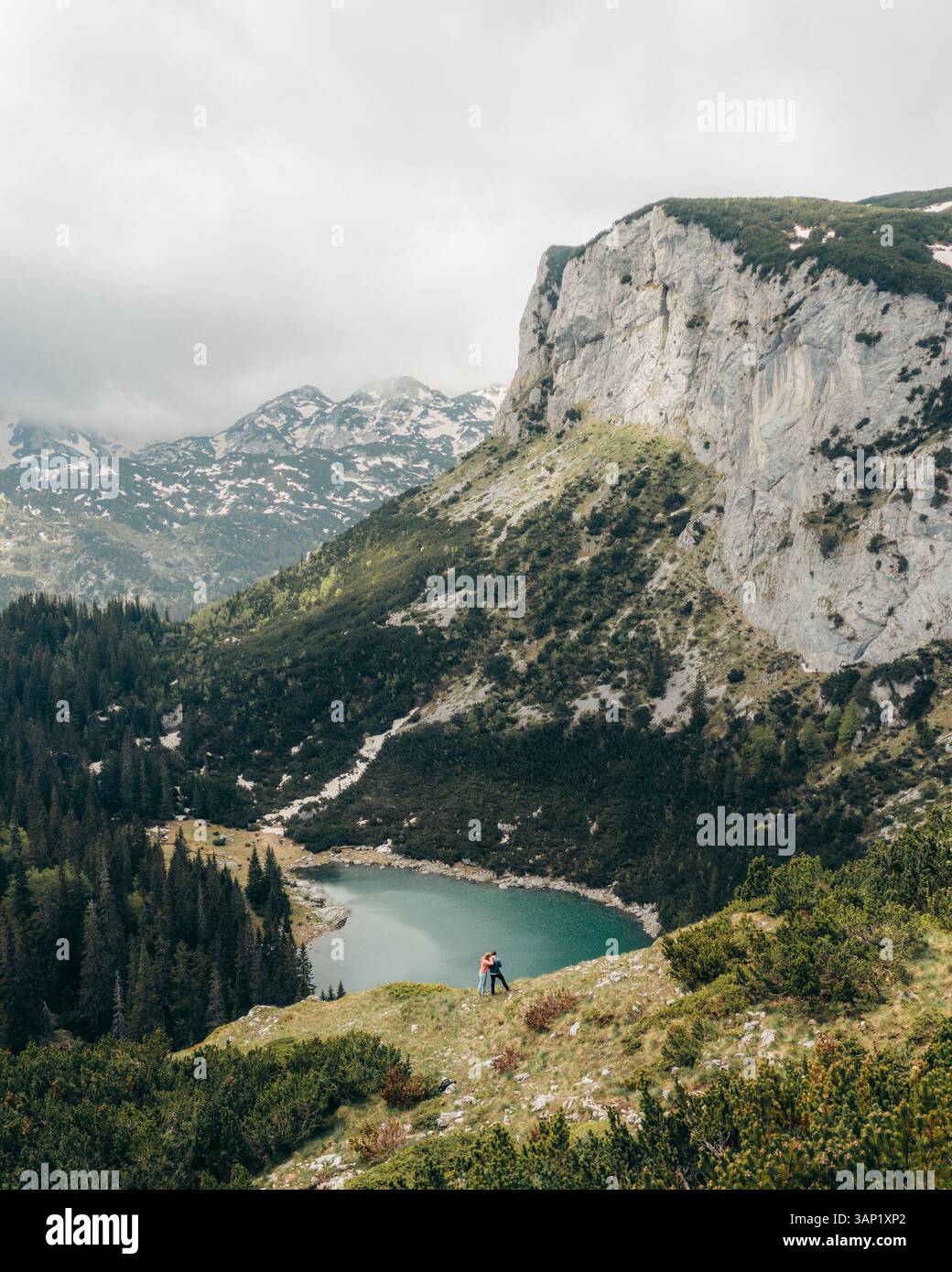 Aerial view of Jablan Lake surrounded by majestic mountains and lush ...