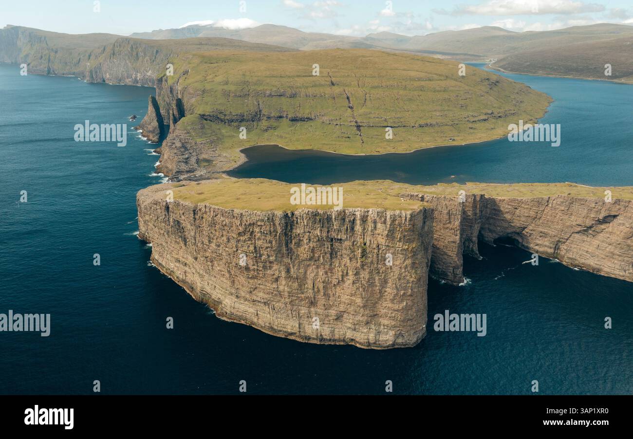 Aerial view of dramatic cliffs and rugged coastline by the ocean ...