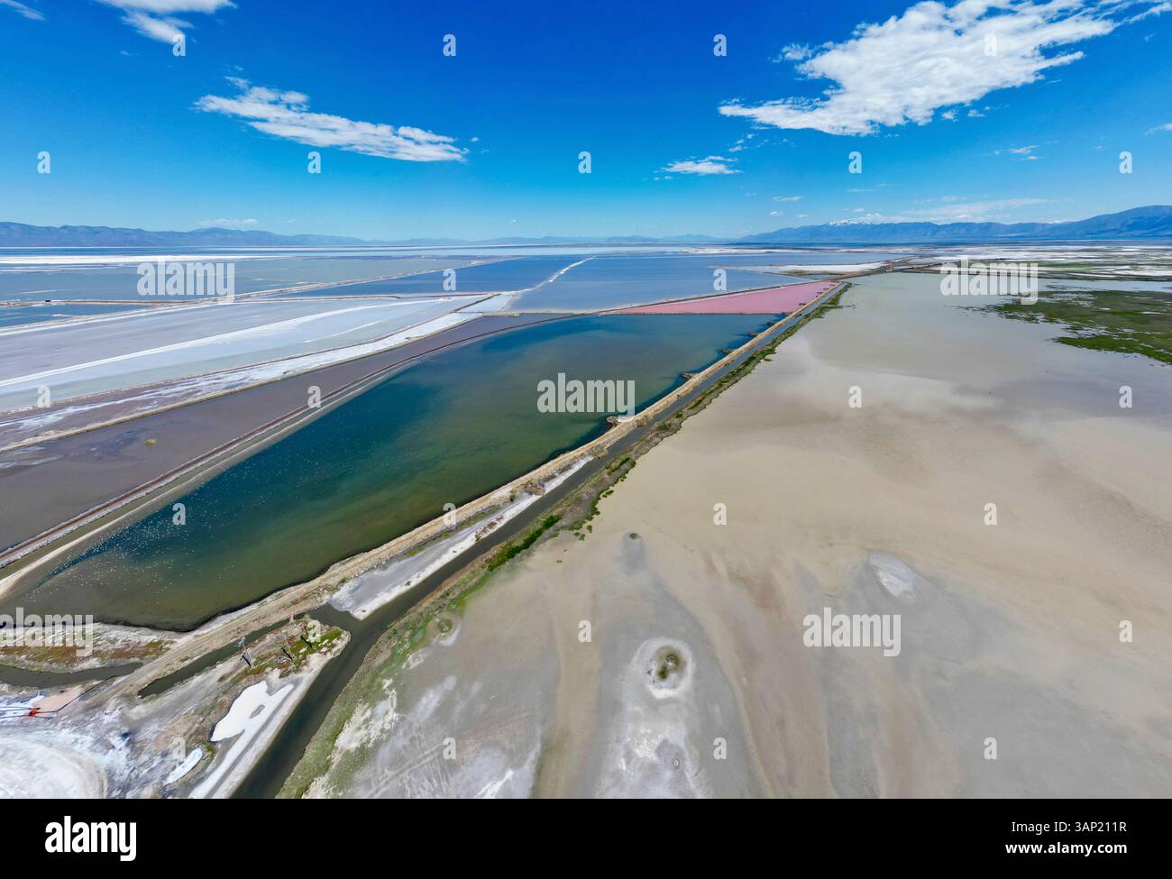Aerial view of mineral pools and Great Salt Lake with mountainous ...