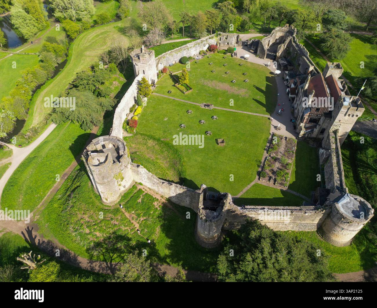 Aerial view of Caldicot Castle with greenery, garden, walls, towers ...