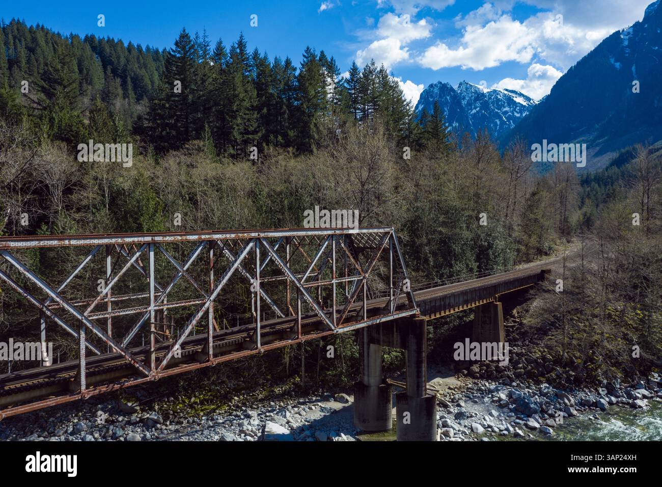 Aerial view of remote railway bridge crossing Skykomish River with ...