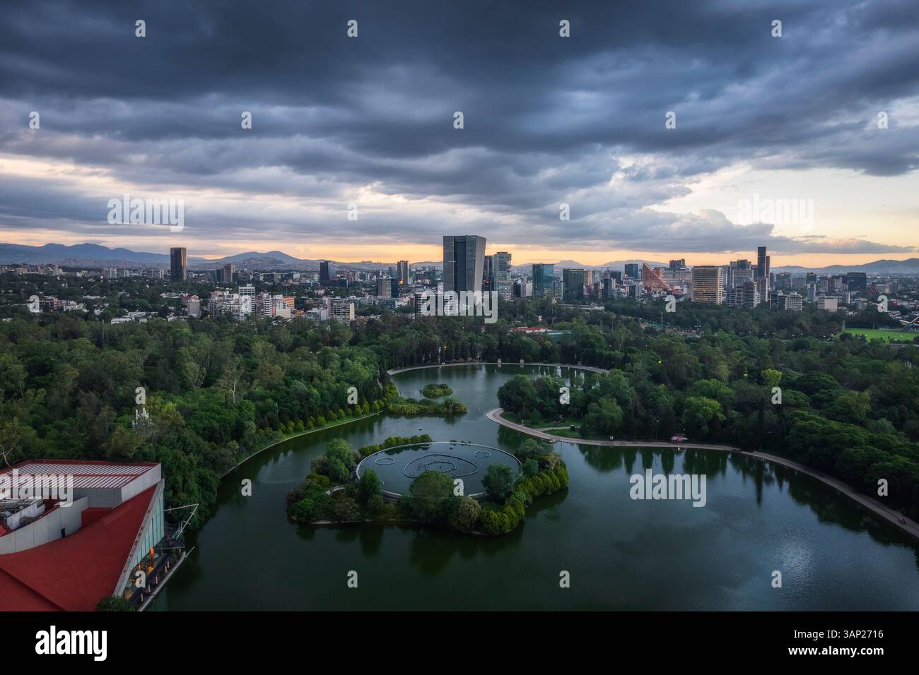 Aerial view of Chapultepec Lake surrounded by modern skyline and lush ...