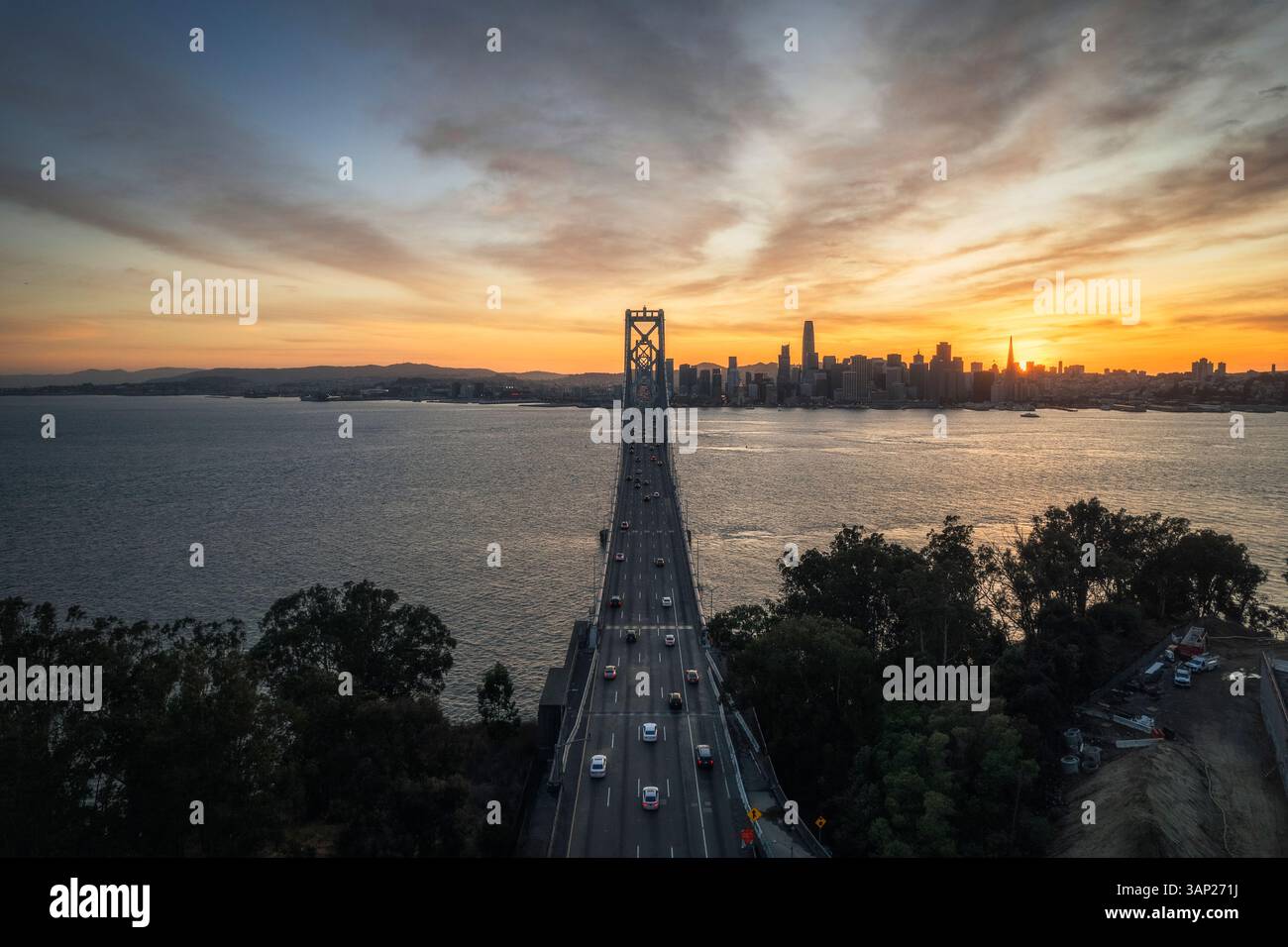 Aerial view of bay bridge at sunset with cityscape and skyline ...