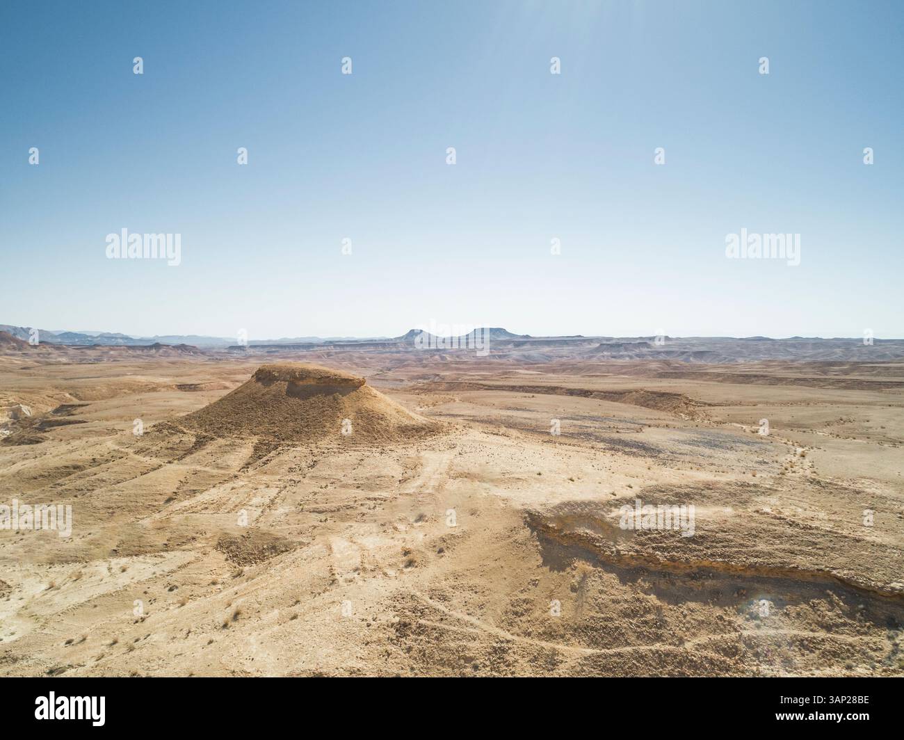 Aerial view of dry desert landscape with high dunes and rocky ...