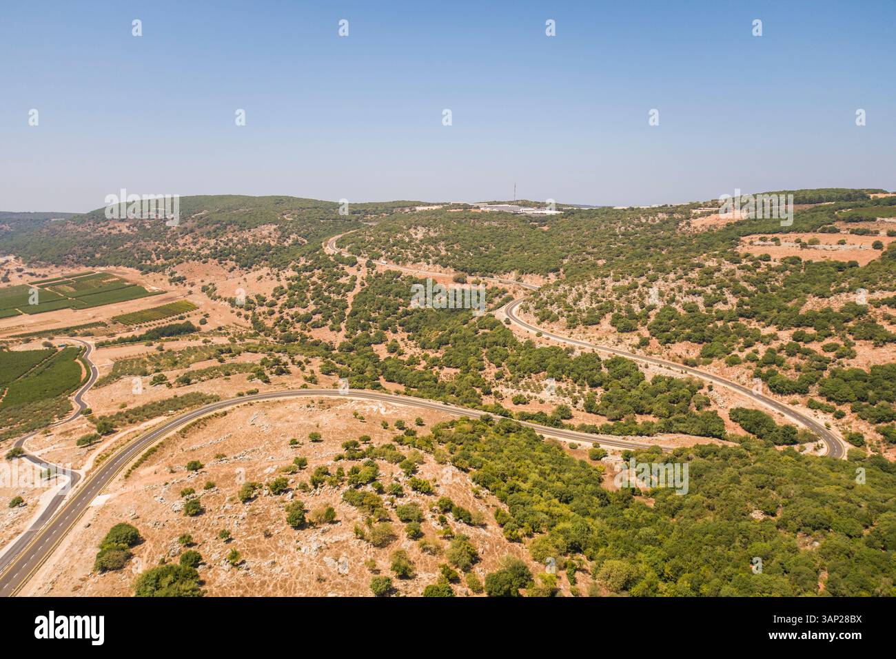 Aerial view of countryside with winding road and greenery, Northern ...