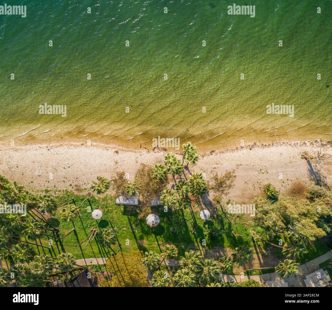 Aerial view of parasols on the lakefront beach at luxury resort along ...