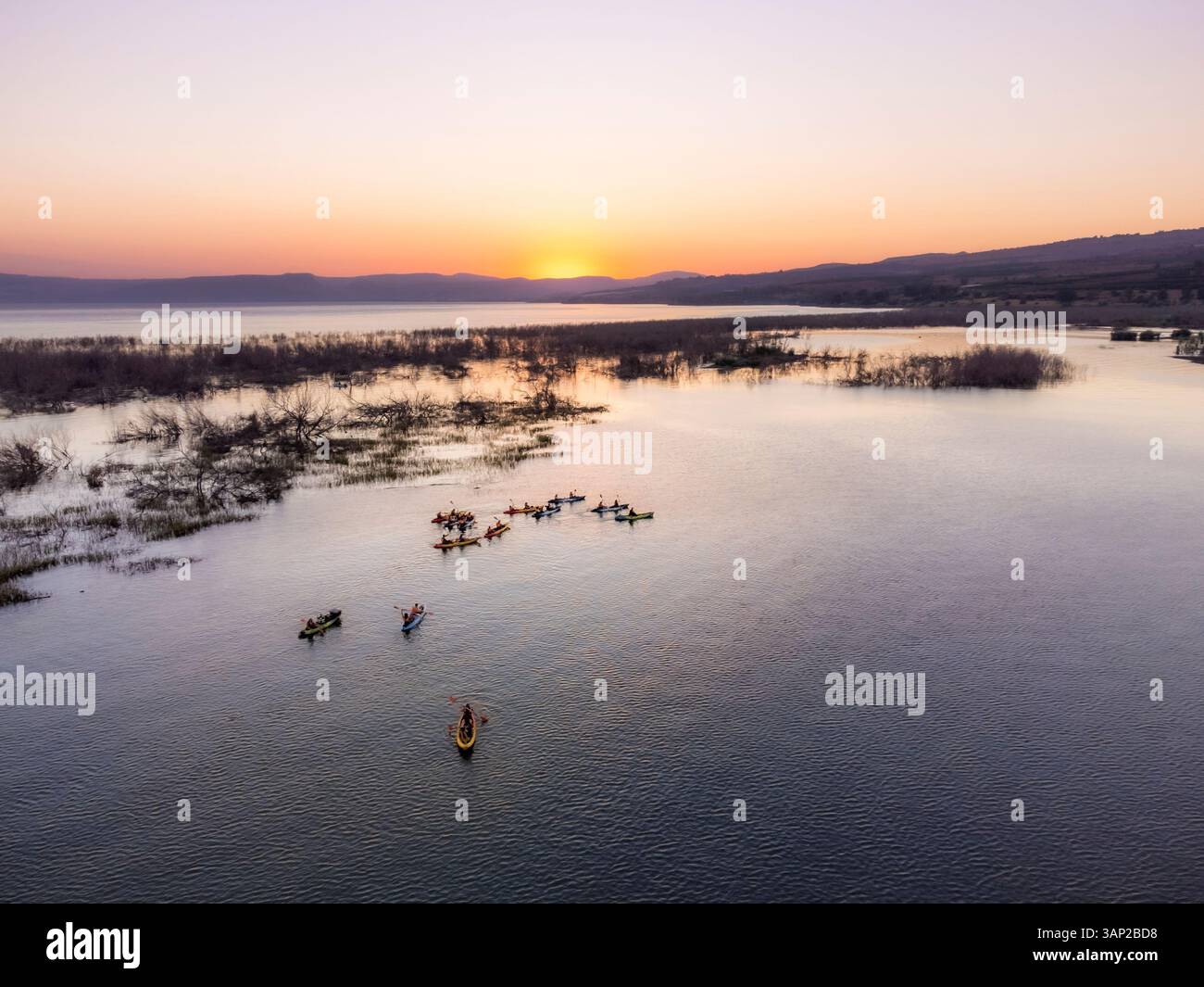 Aerial view of people kayaking in a lake at sunset, Sea of Galilee ...