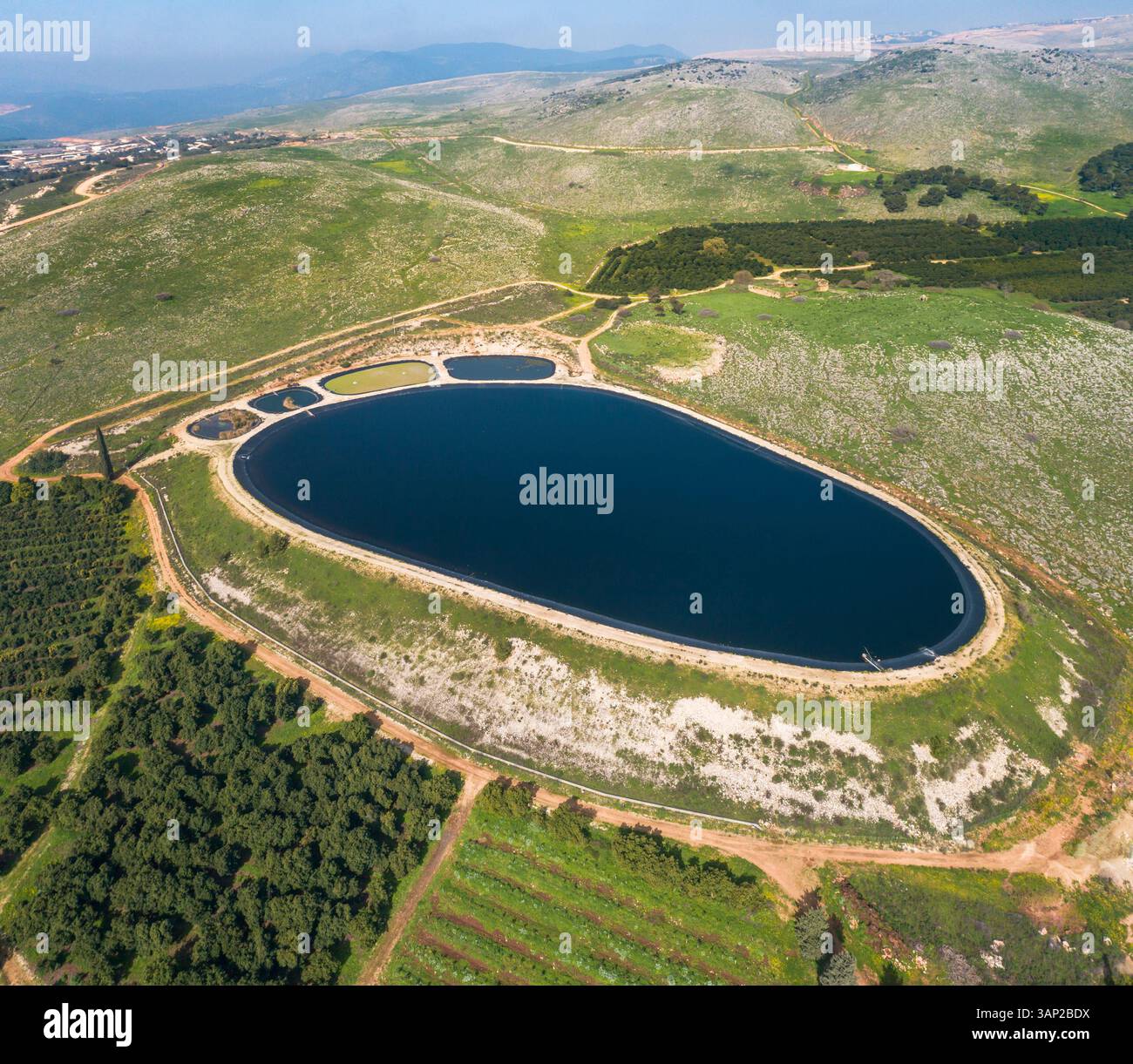 Aerial view of reservoir in a shape of a big foot. Amiad, Northern ...