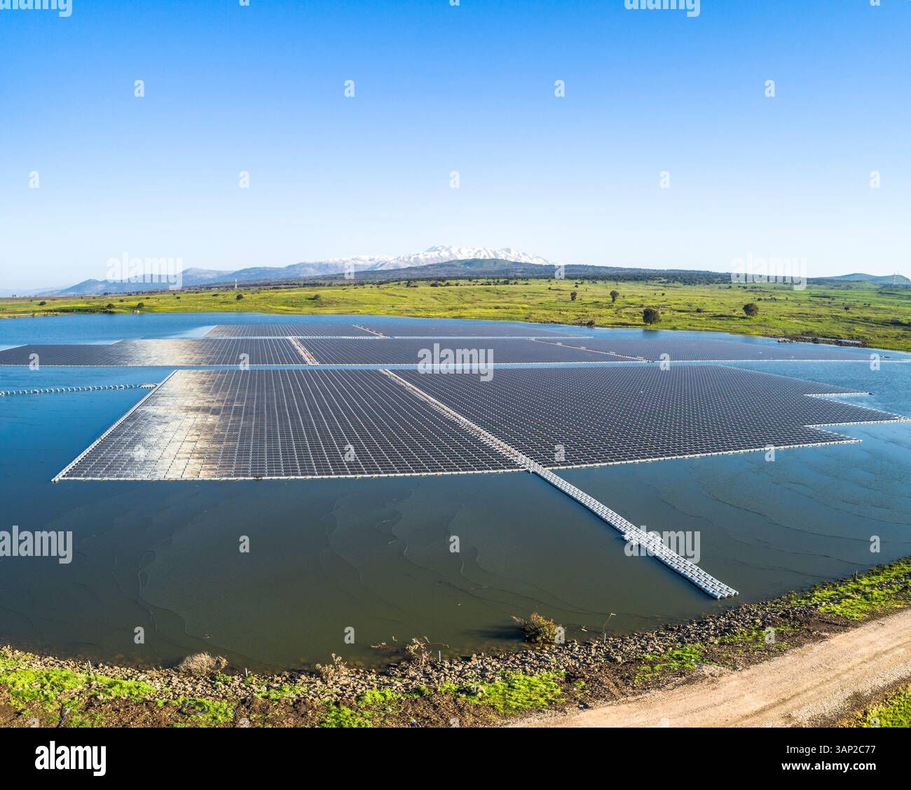 Aerial view of a water reservoir covered with floating solar panels ...