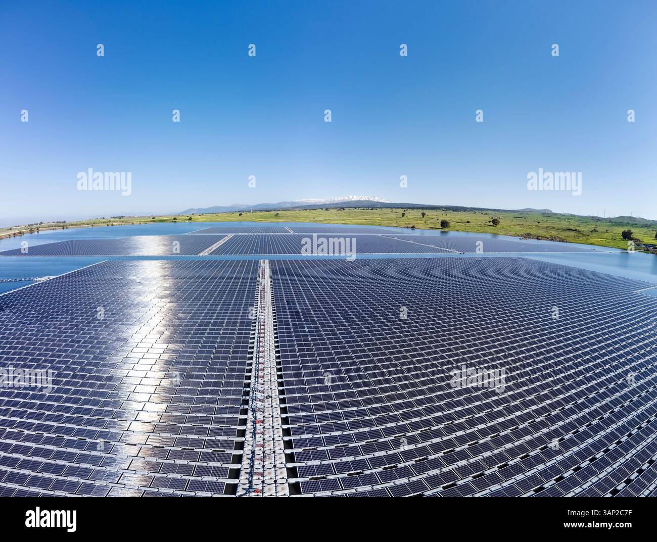 Aerial view of a water reservoir covered with floating solar panels ...