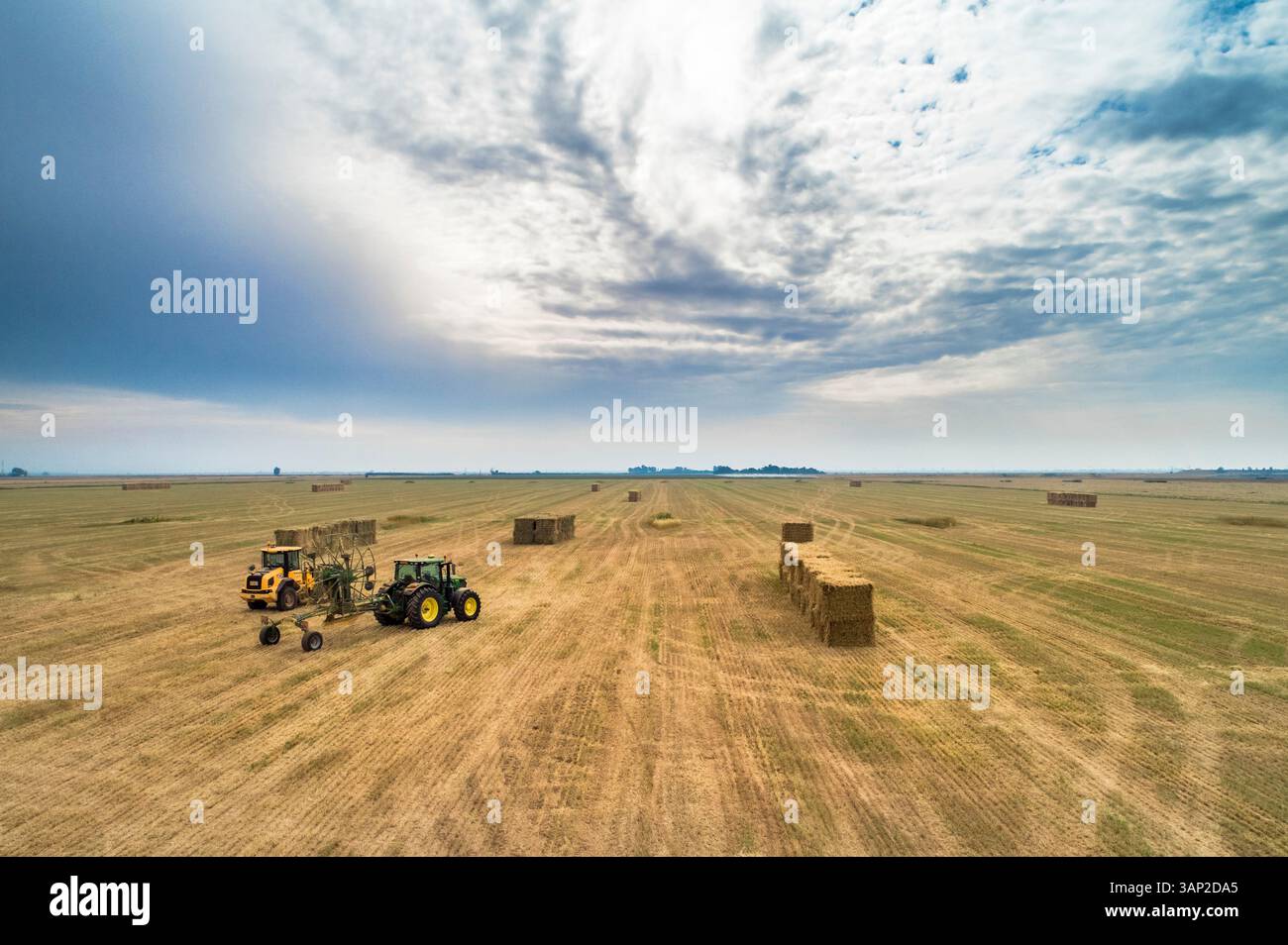 Aerial view of a tractor in a harvested wheat field, Negev, Israel ...