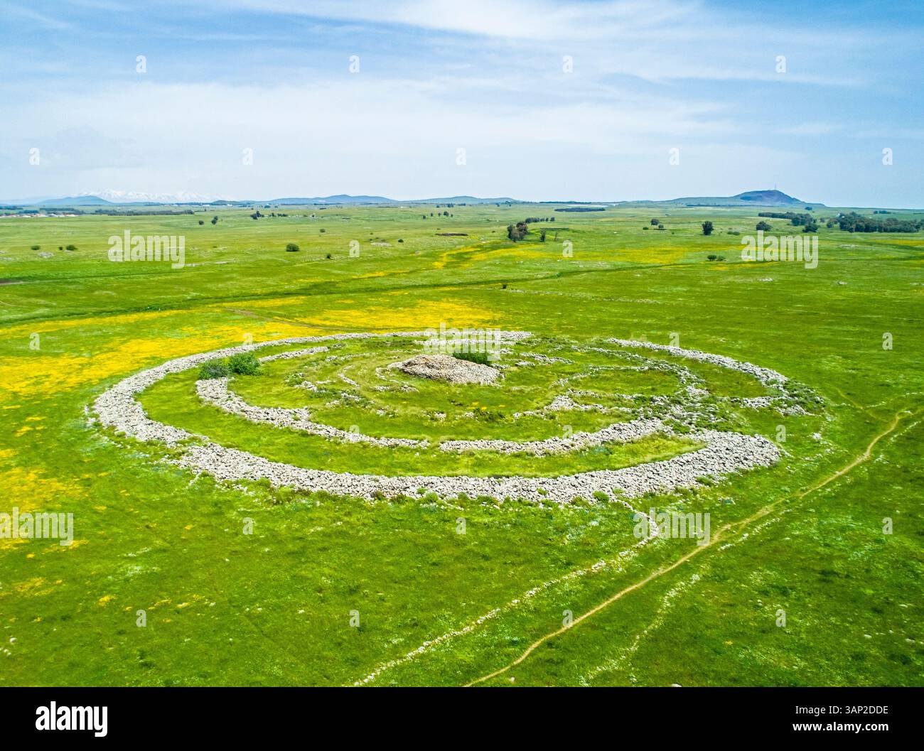 Aerial view of ancient megalithic monument in grassland, Rujum Al-Hiri ...