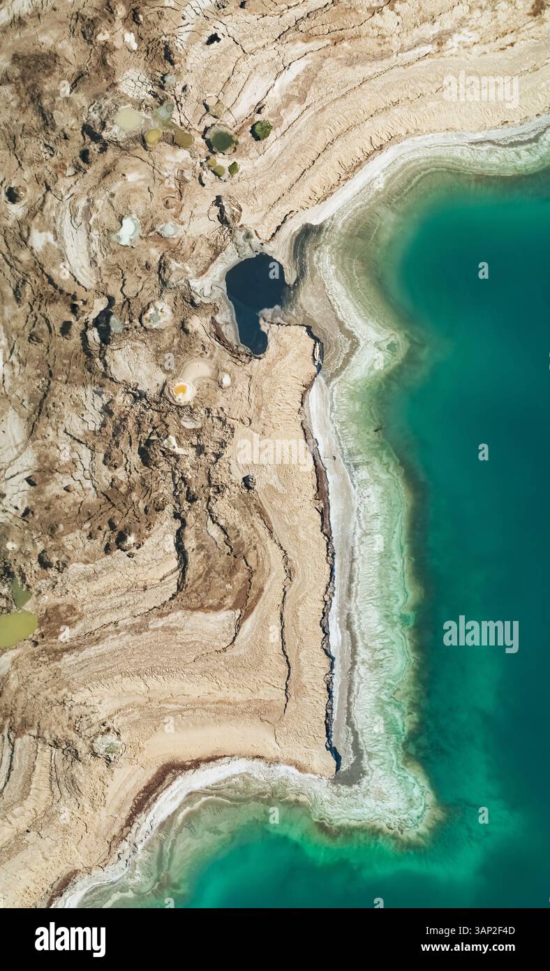 Aerial view of colourful sinkholes along Dead Sea shoreline in Negev ...