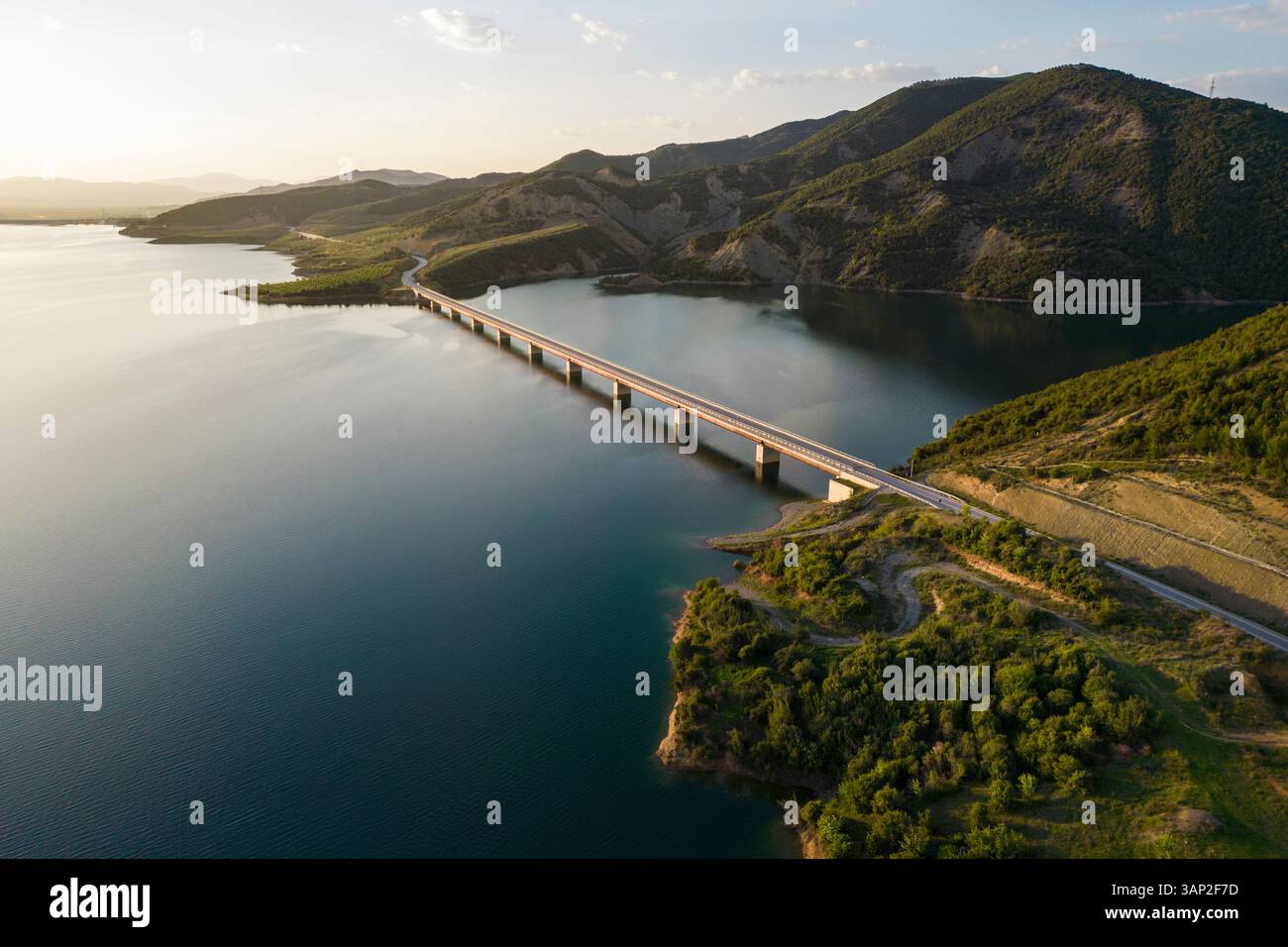 Aerial view of Lake Banjes with mountain peaks in sunset, Gramsh ...