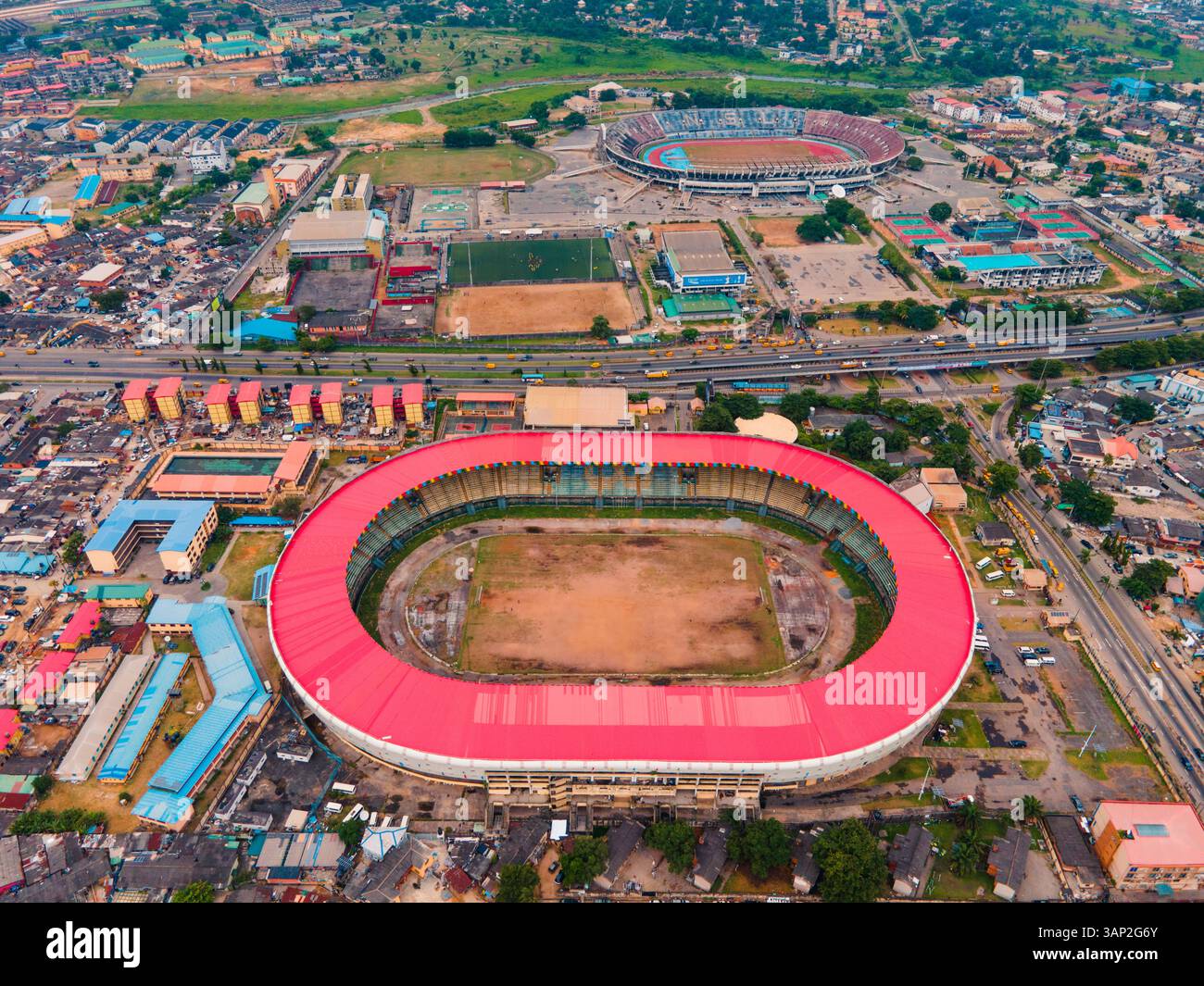 Aerial view of vibrant stadium and bustling urban landscape with modern buildings and greenery ...