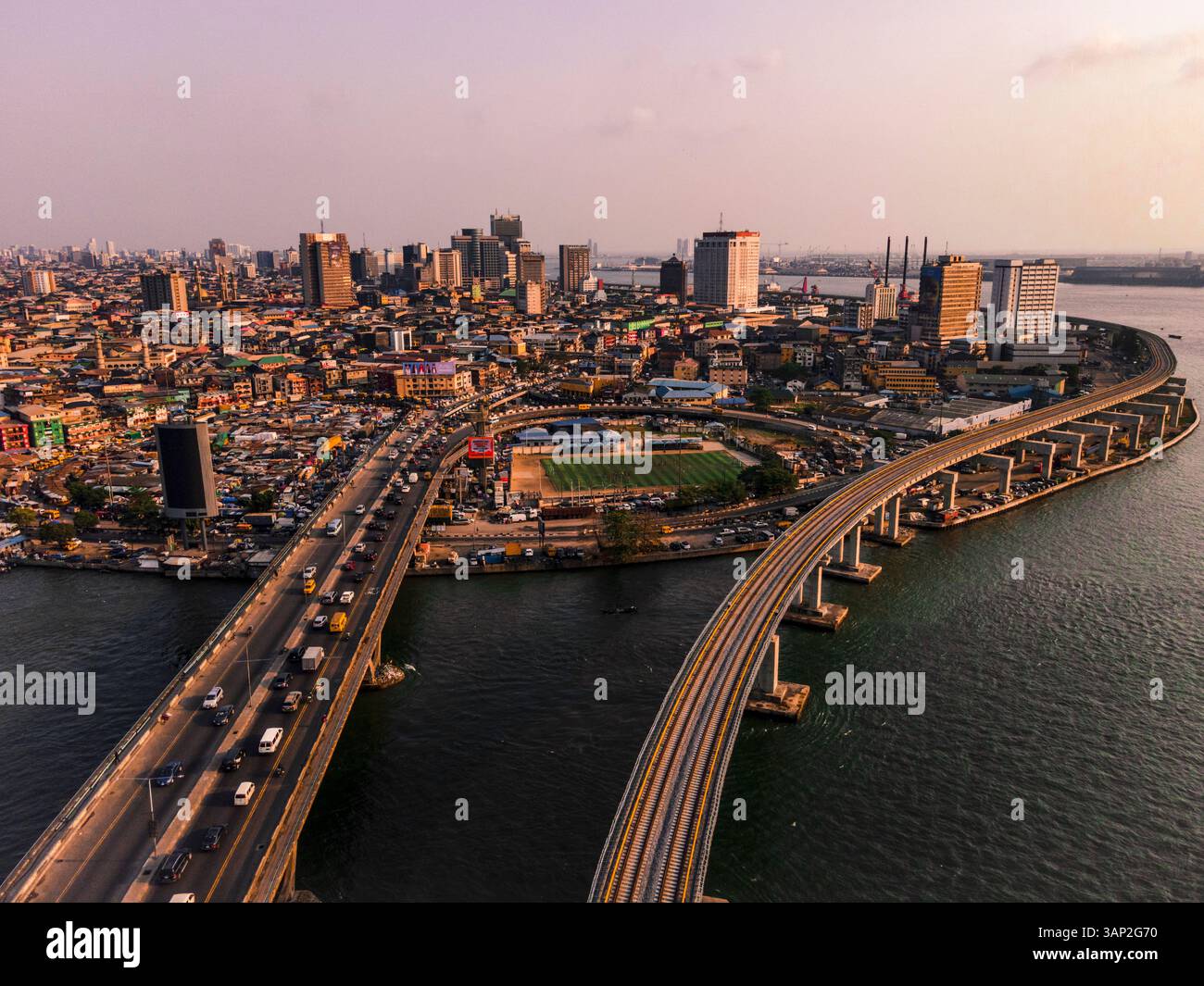 Aerial view of beautiful cityscape with lekki ikoyi link bridge and skyscrapers over water ...