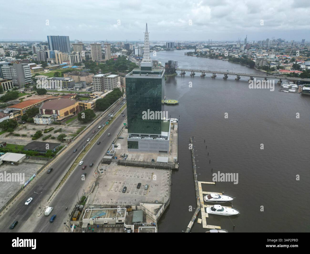 Aerial view of bustling urban landscape with high-rise buildings, a river, and a bridge, Lagos ...