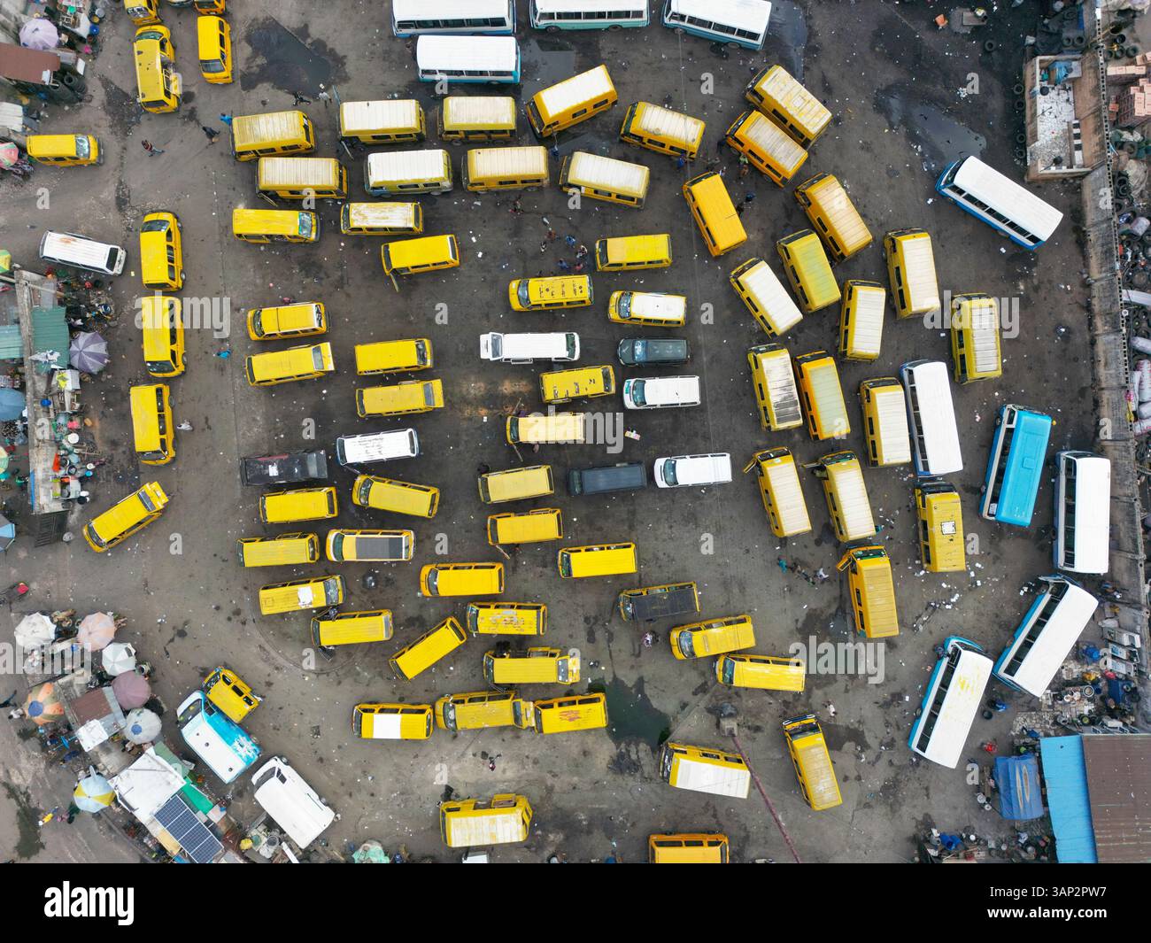 Aerial view of busy urban traffic with yellow buses and vehicles in a ...