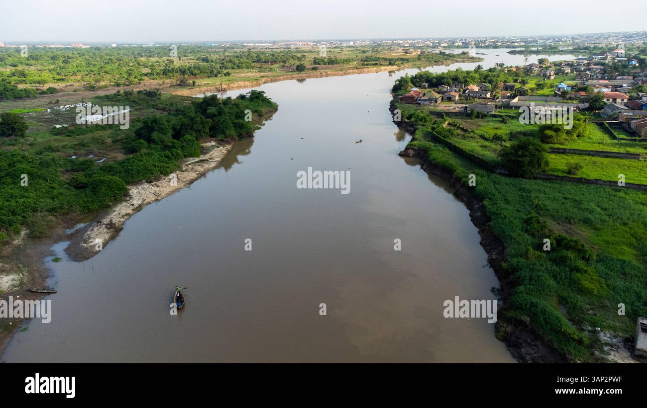 Aerial view of the serene Ogun River with lush greenery and a tranquil ...