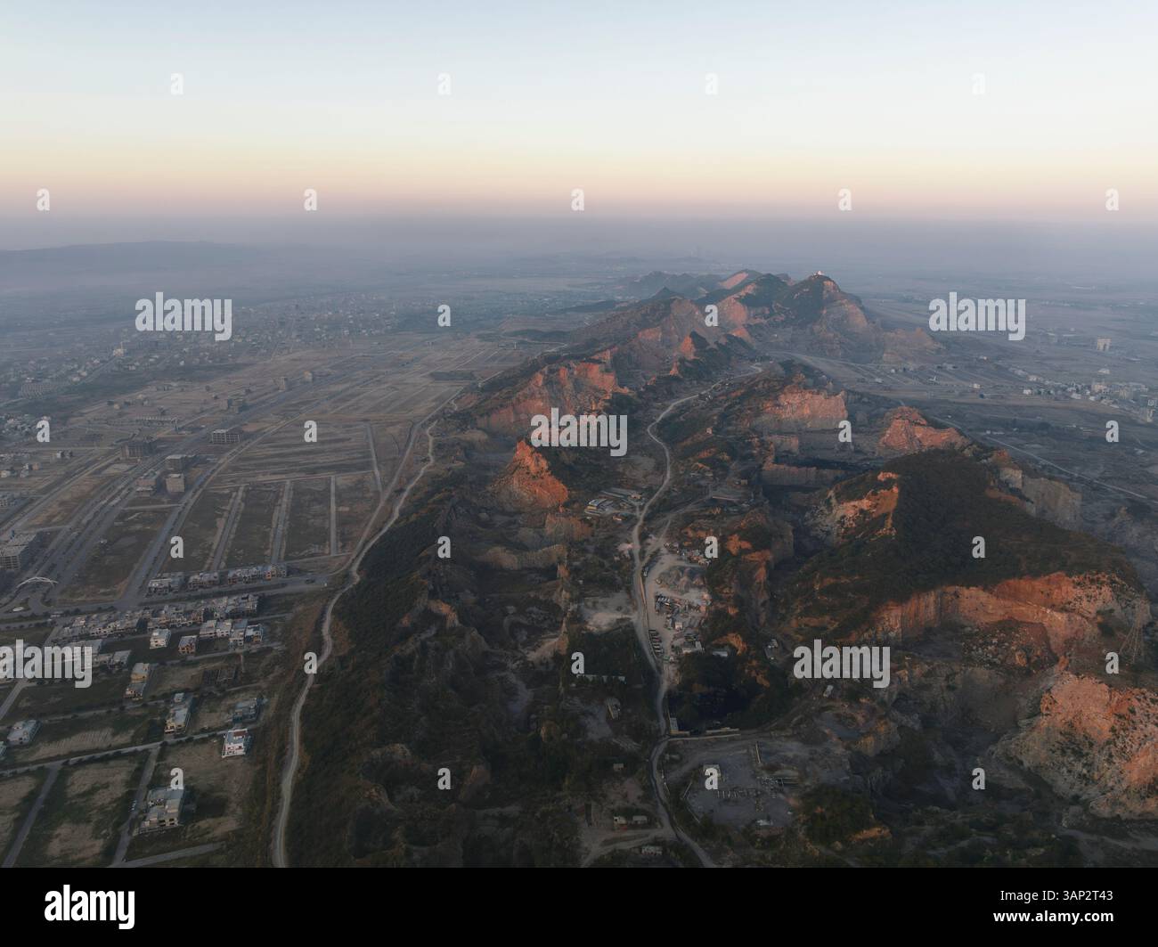 Aerial view of hills during sunrise in residential area B-17 in ...