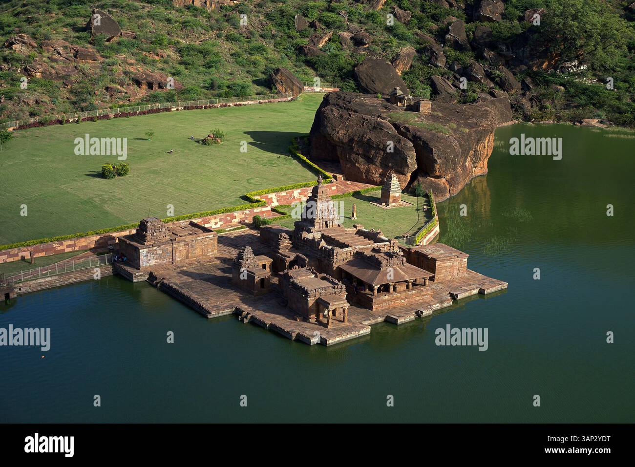 Aerial view of ancient Badami temple ruins with greenery and a lake ...