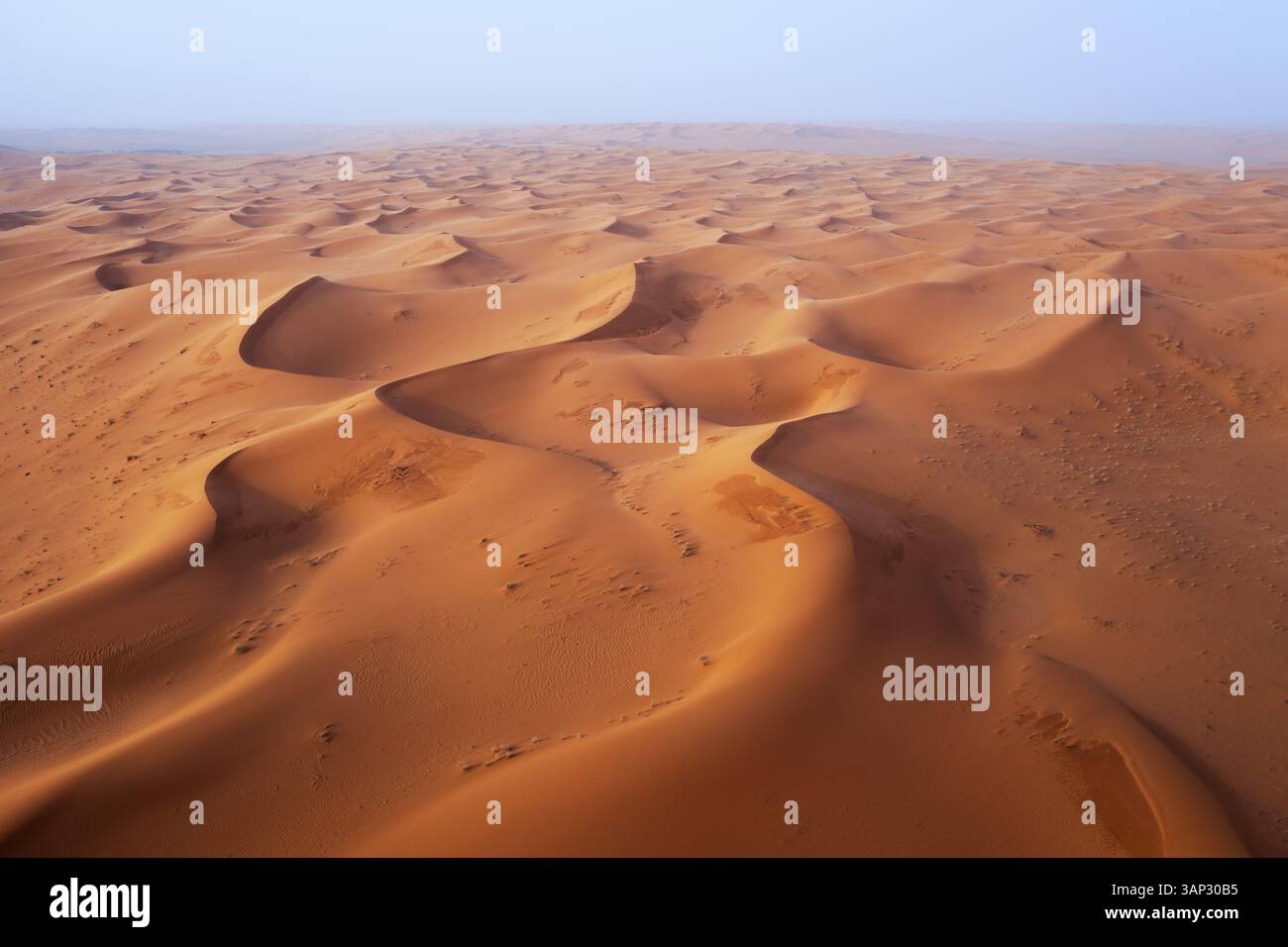 Aerial view of beautiful sand dunes with undulating shapes and serene ...