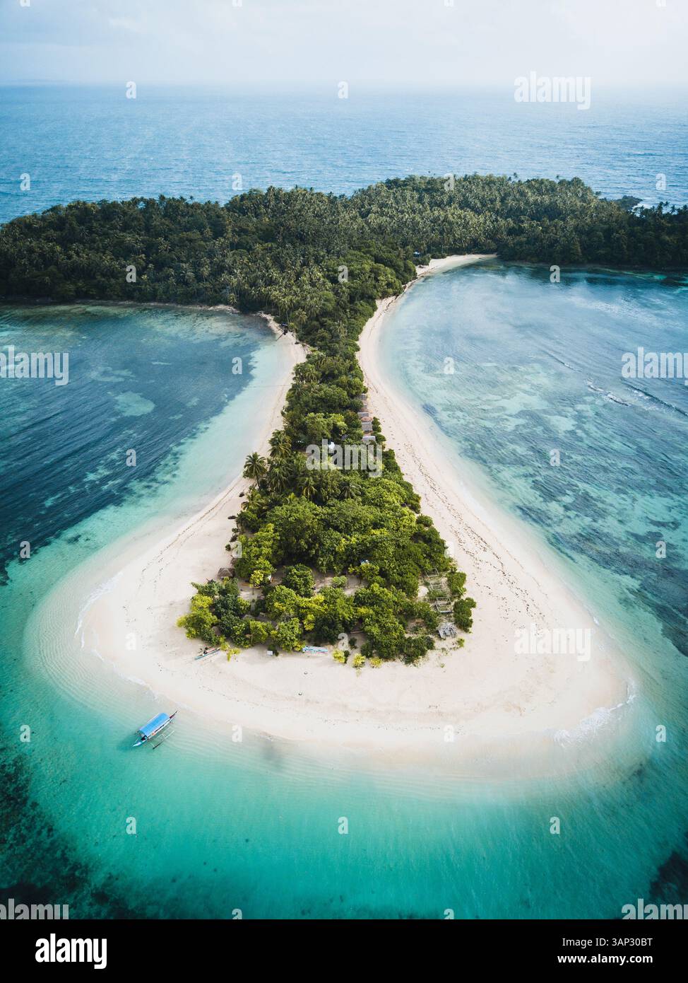 Aerial view of Cabgan Islet surrounded by turquoise water in Barobo ...