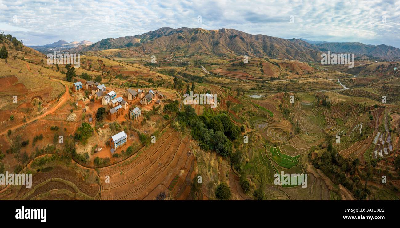 Aerial view of rice terraces and village nestled in hills and fields ...