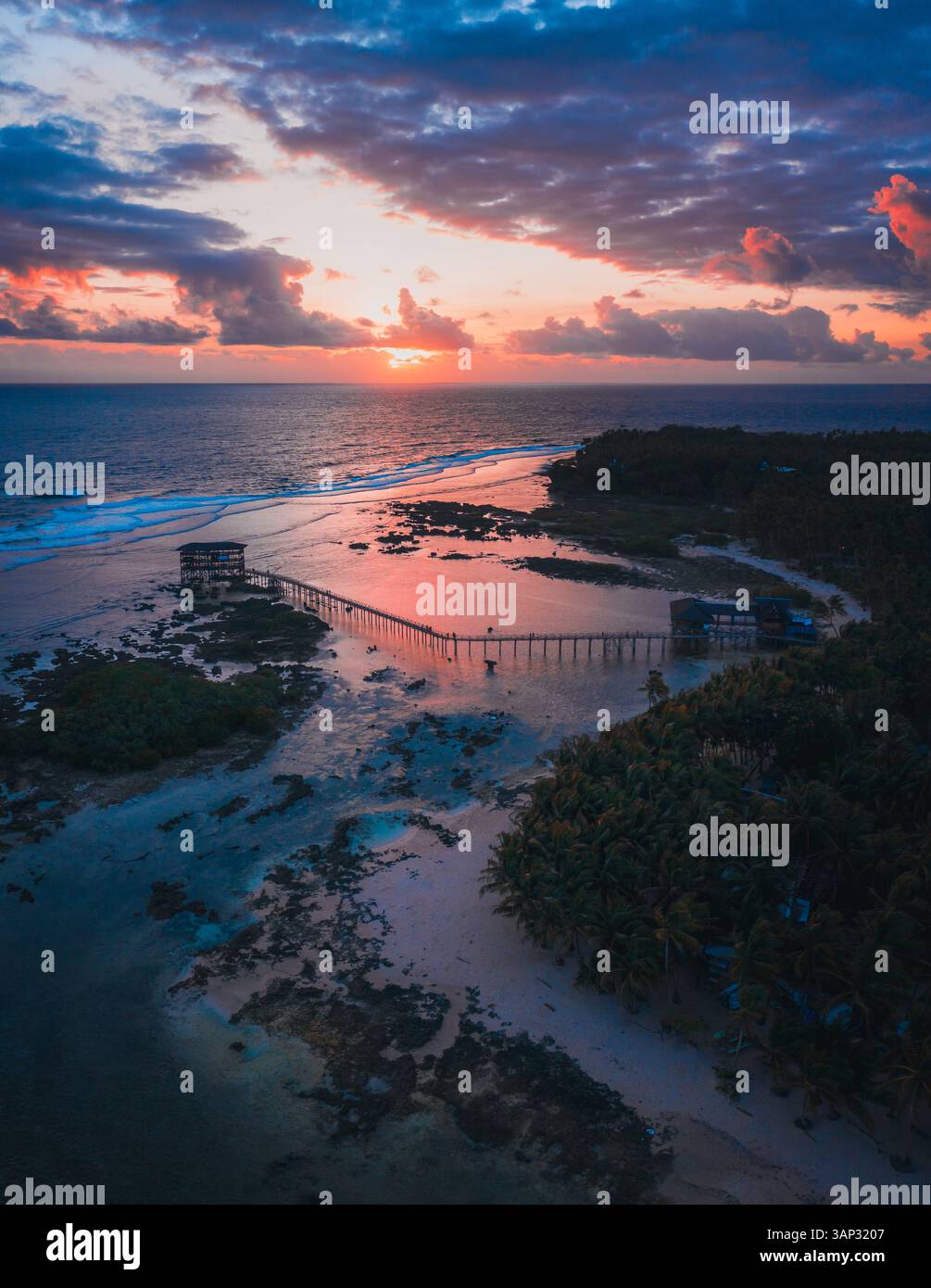 Aerial view of a pier at sunset in General Luna, Surigao del Norte ...