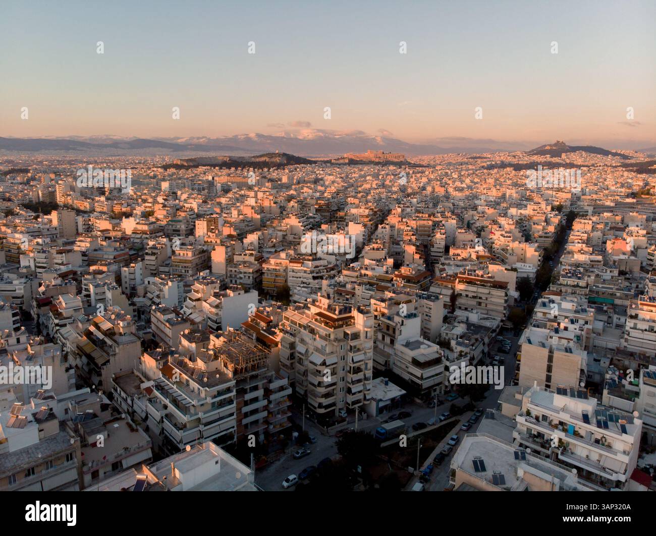Aerial view of the Acropolis in the distance and houses rooftops of the city of Athens, Greece ...