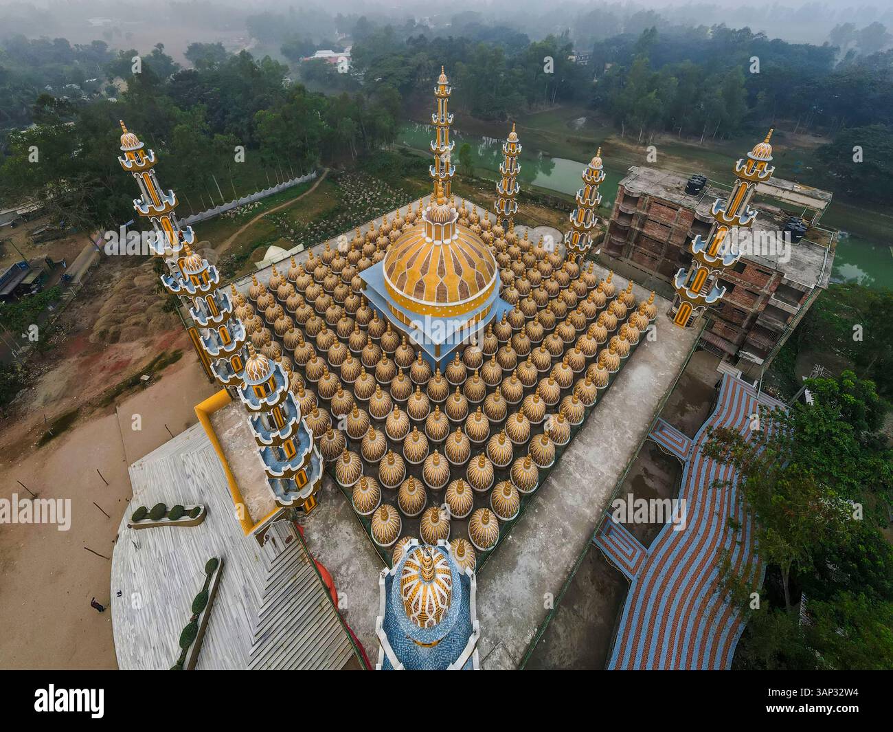 Aerial view of the beautiful 201 Dome Mosque surrounded by lush trees ...
