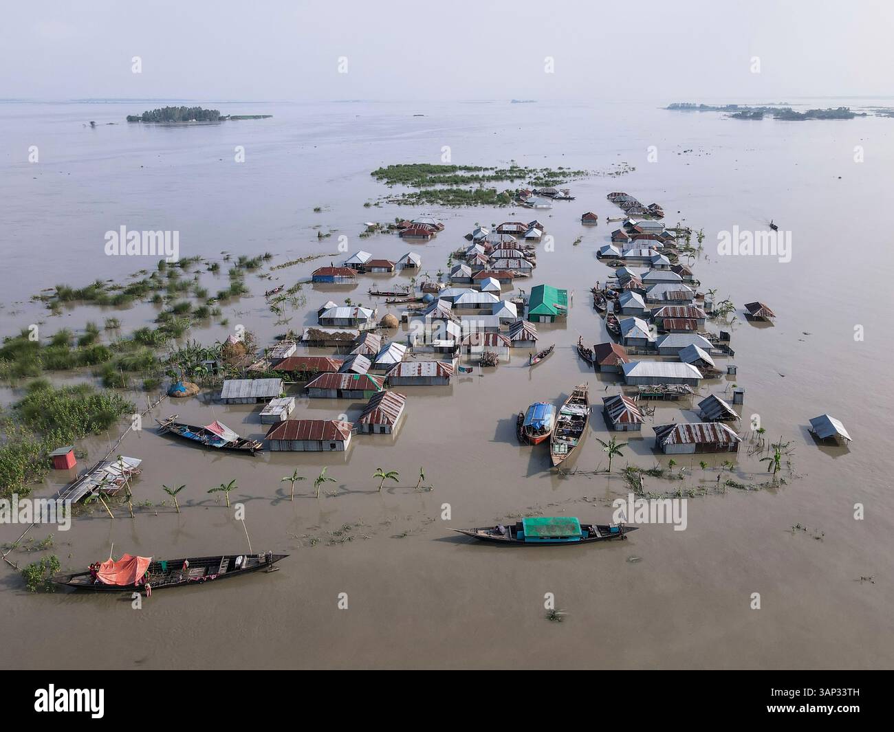 Aerial view of flood water inundating homes and boats in a small town ...