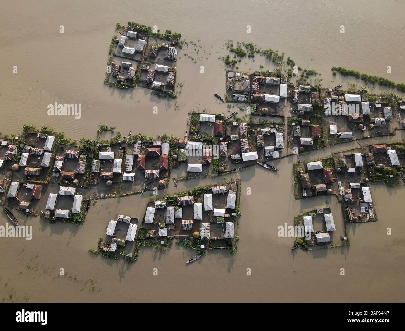 Aerial view of flood-affected homes and boats in a small town, Jatrapur, Kurigram, Bangladesh ...