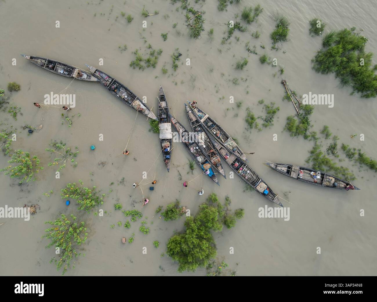 Aerial view of flood water inundating a rural community with boats and ...