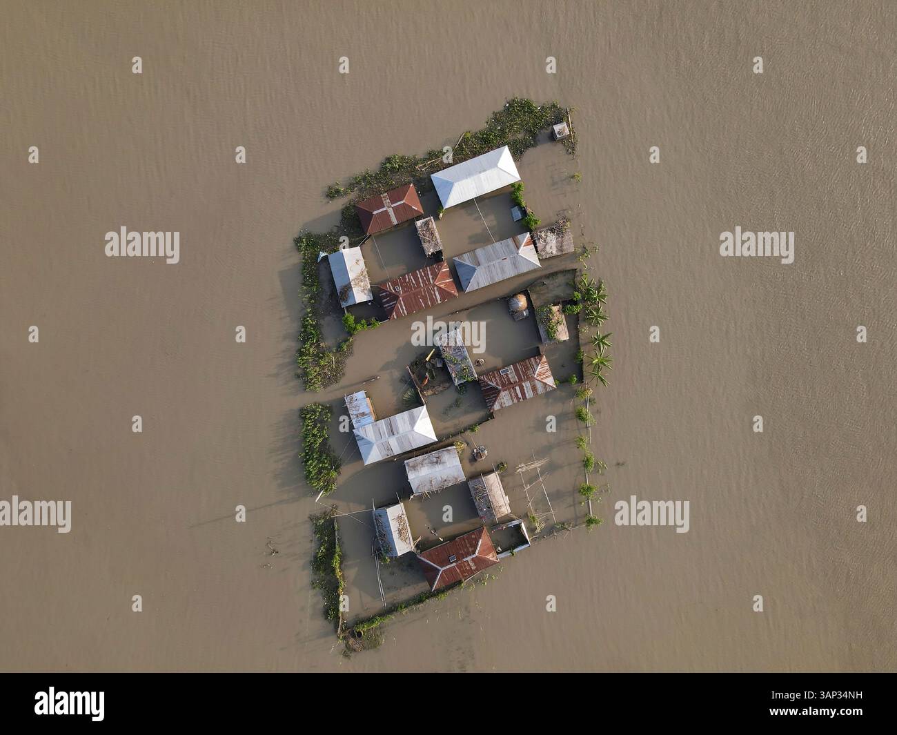 Aerial view of submerged village homes surrounded by flood water, Jatrapur, Kurigram, Bangladesh ...