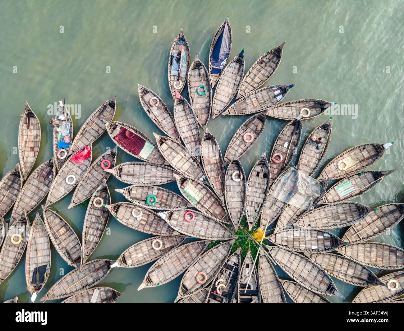 Aerial view of colorful boats on the Buriganga River amidst the bustling city of Dhaka, Dhaka ...