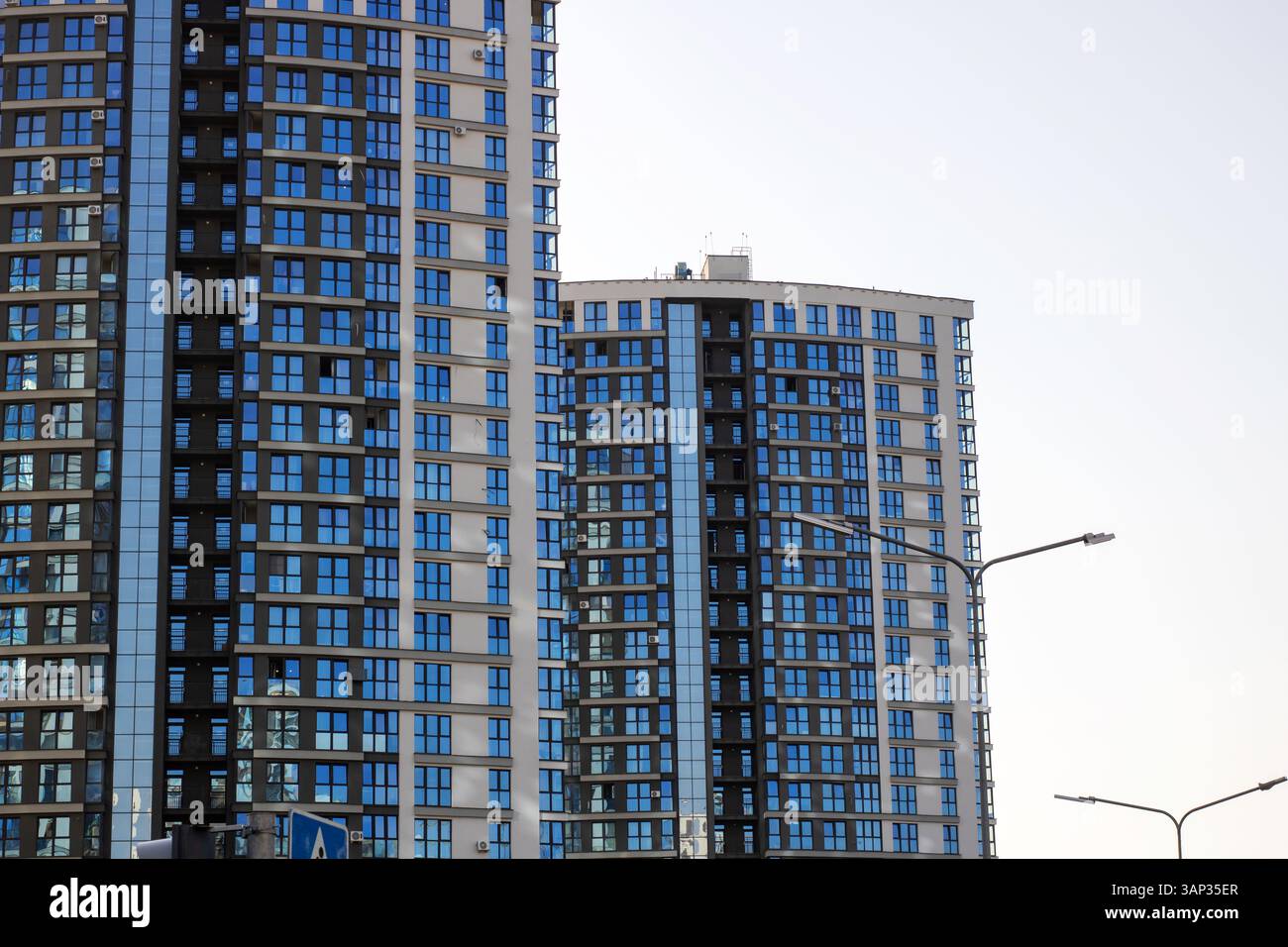 A very tall building prominently features a large sign that clearly ...