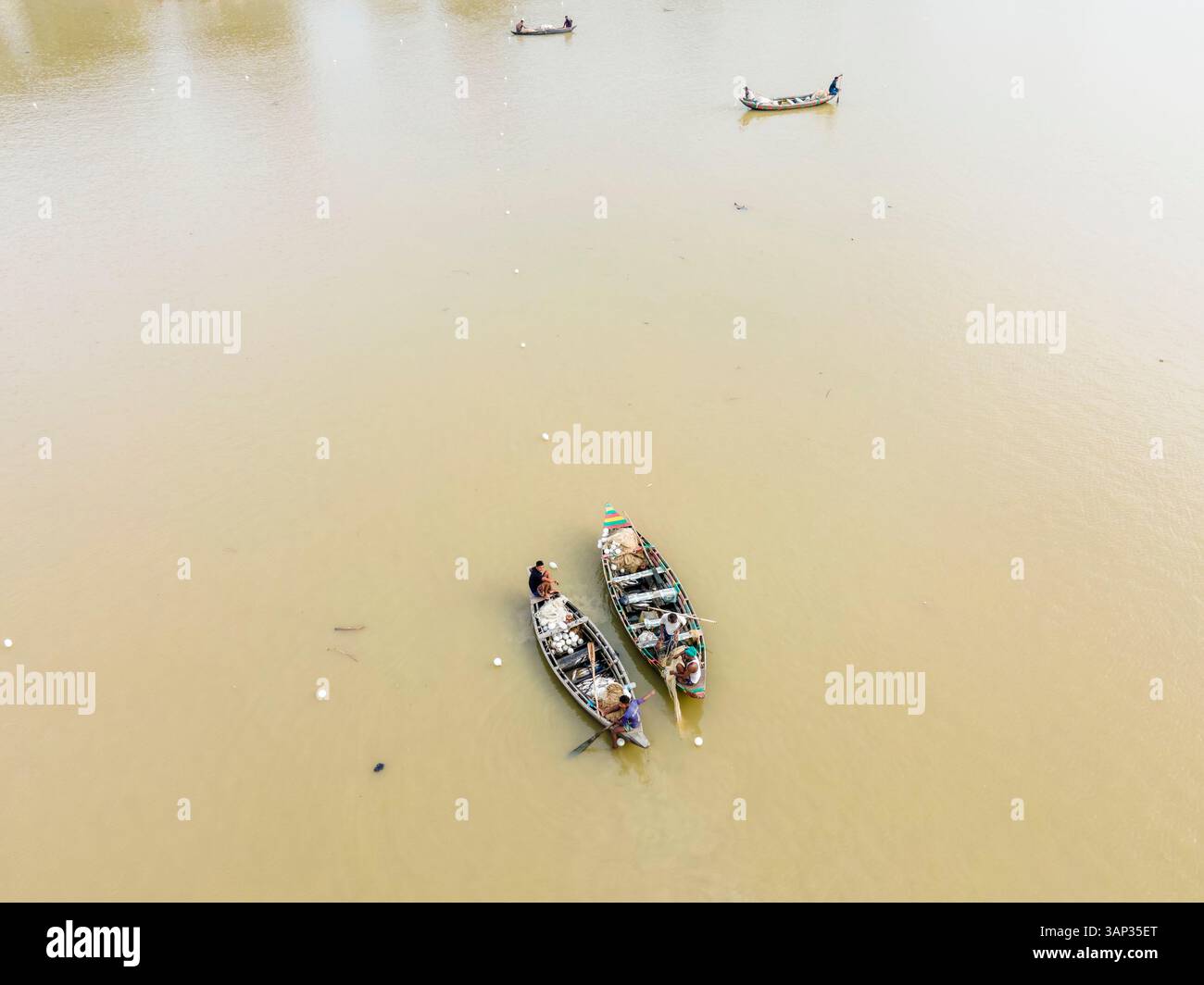 Aerial view of fishing boats on flood water with a resilient community ...