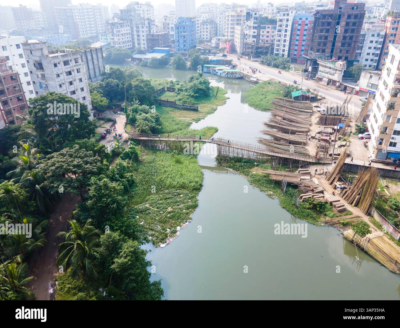 Aerial view of a bustling urban scene featuring a bamboo bridge over a ...