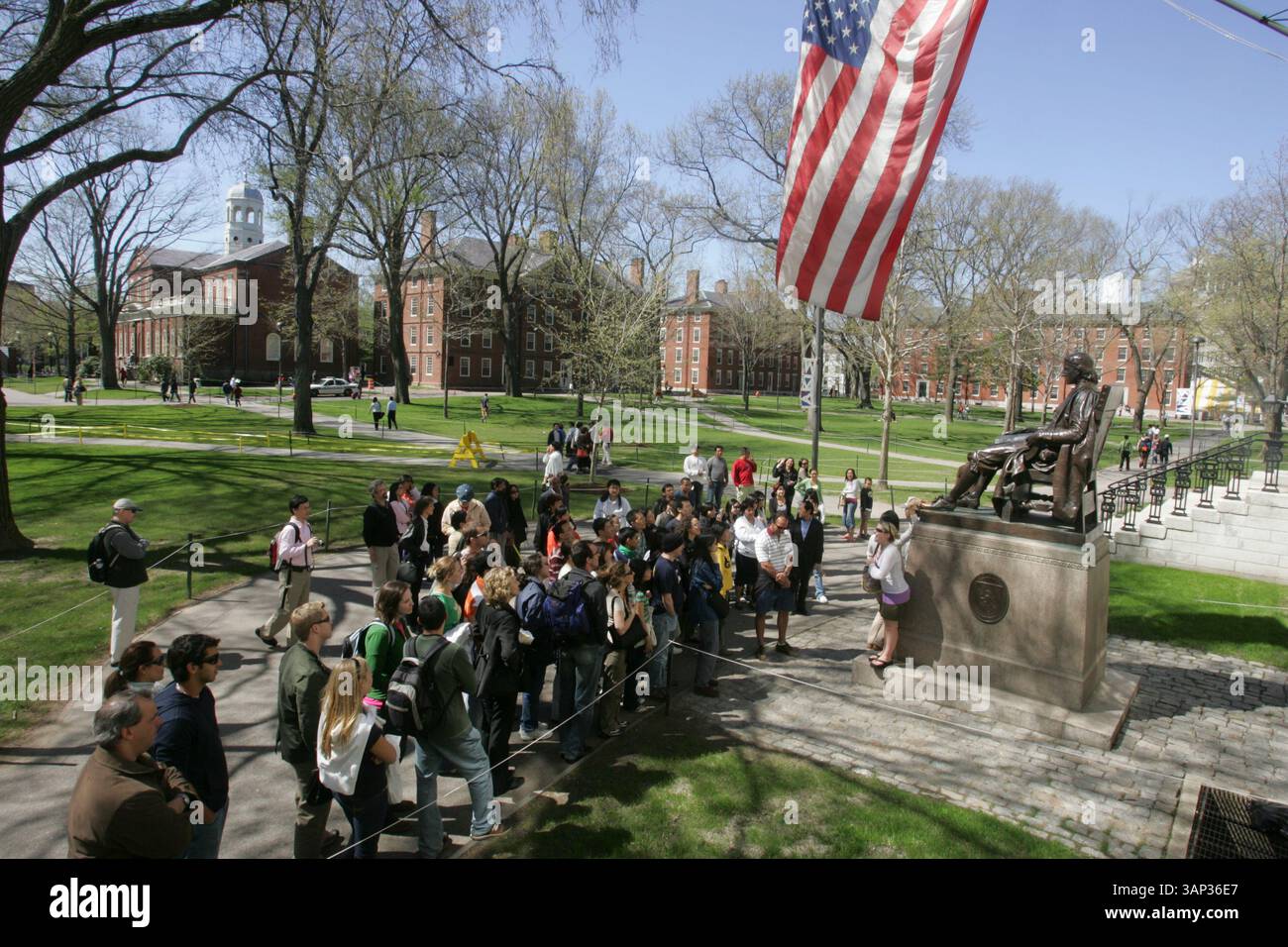Cambridge, Massachusetts, USA Tourists in front of John Harvard statue ...