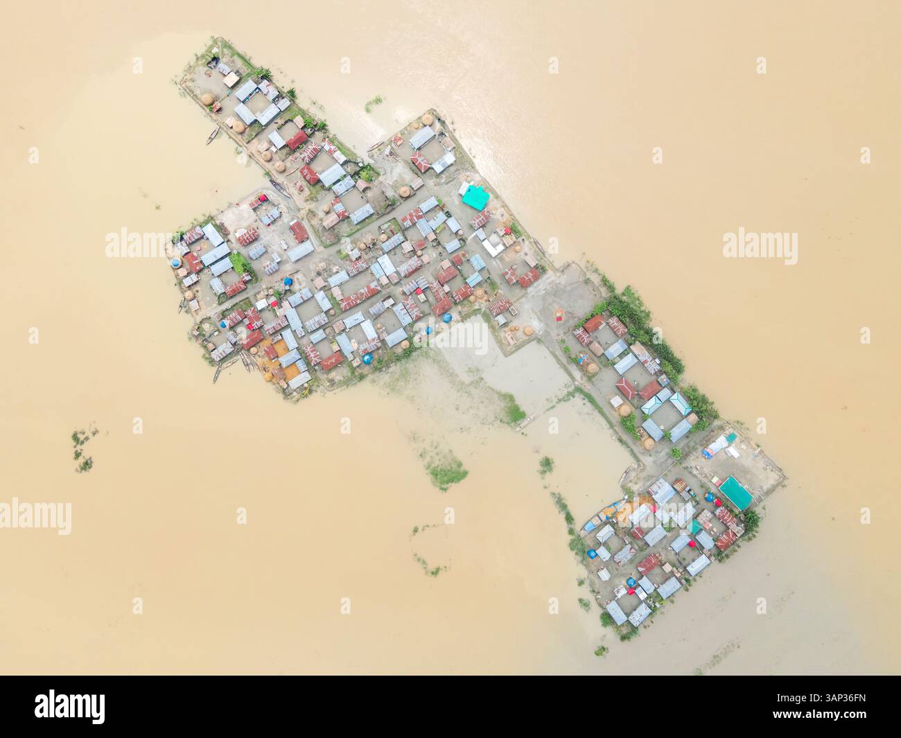 Aerial view of a devastated and submerged village with floating homes and flooded streets ...