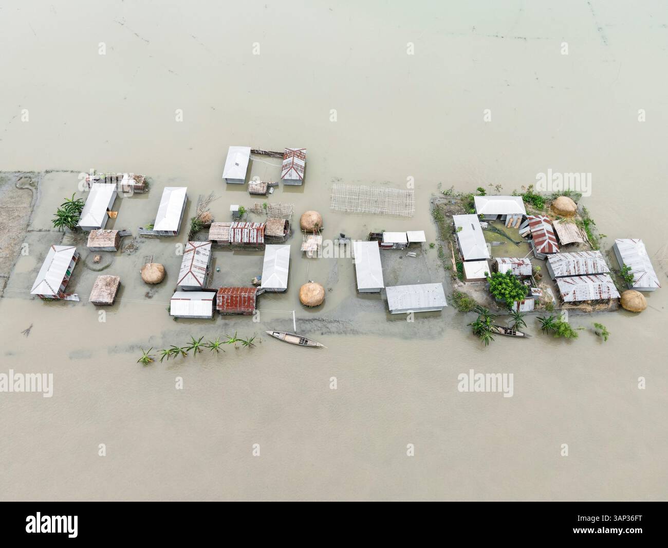Aerial view of submerged and waterlogged village with floating homes amidst rising waters and ...