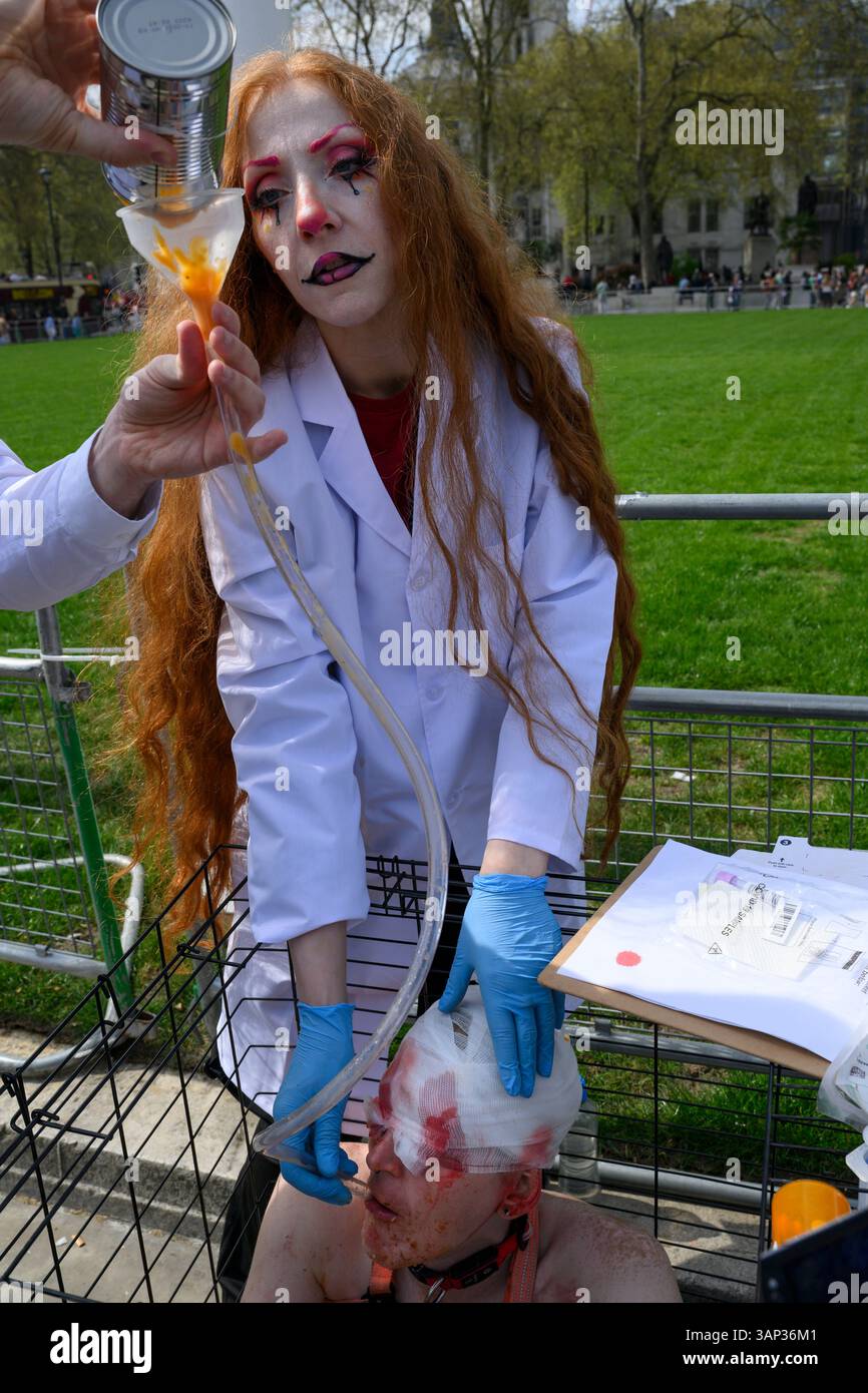 A man in a cage represents animal testing at a pro-animal rights ...