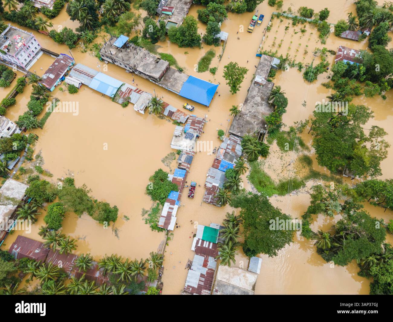 Aerial view of flooded village with submerged homes and waterlogged streets, Mirsarai ...